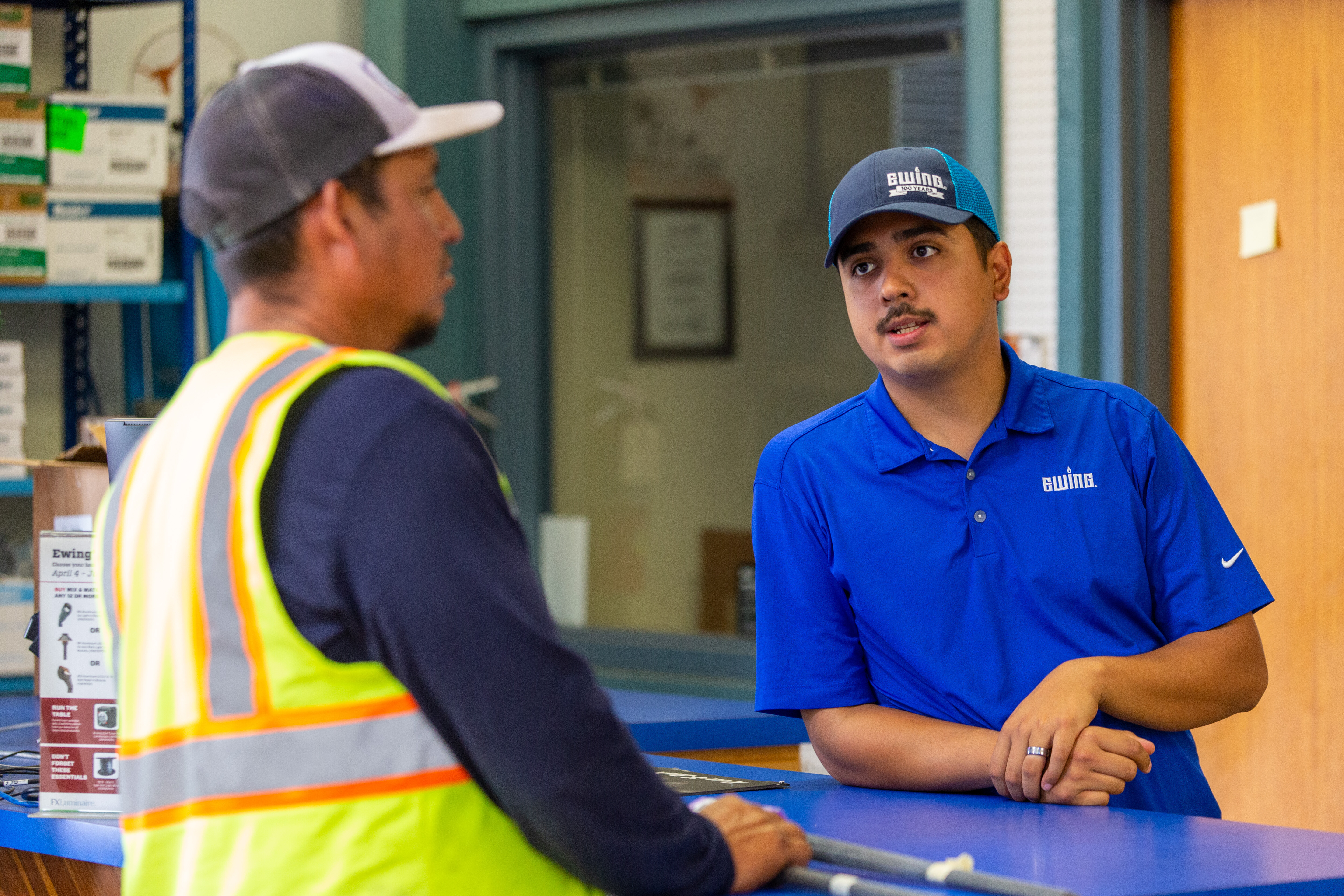 Ewing employee assisting a customer at the front counter (Photo taken ...